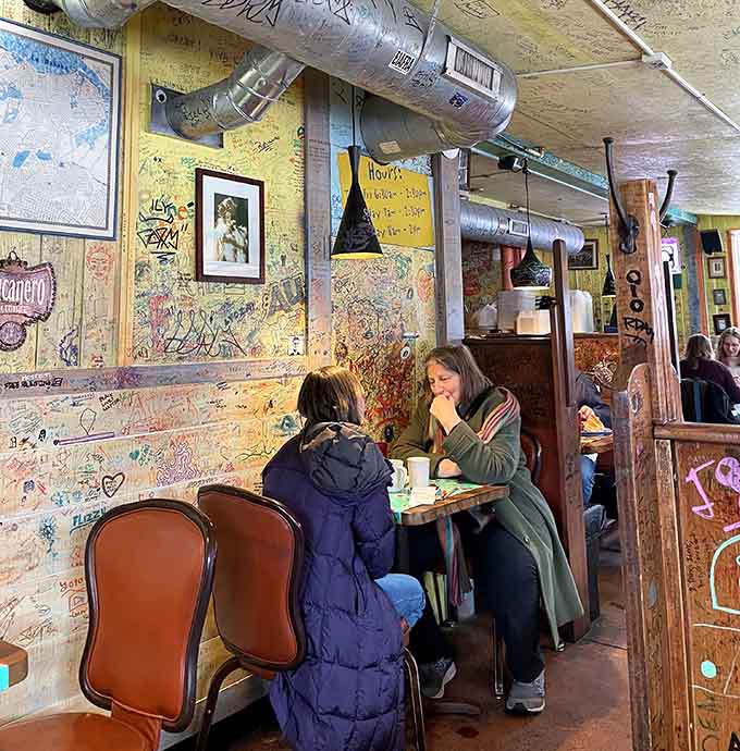 Diners hunched over their meals in happy concentration, surrounded by decades of messages from fellow food pilgrims.