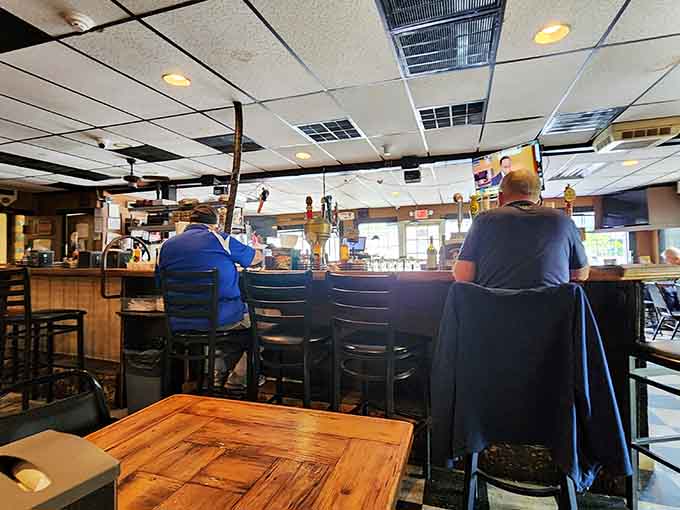 The bar where regulars gather like old friends, and bartenders pour drinks with the efficiency of seasoned professionals.
