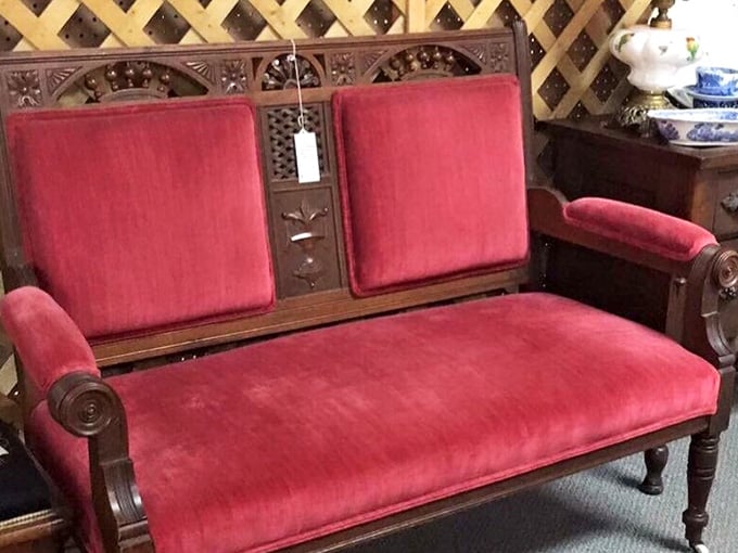 Victorian-era seating with carved details and velvet upholstery that modern furniture can only dream about replicating.