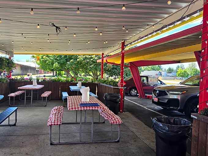 Covered outdoor seating with checkered tablecloths, perfect for summer evenings and oversized appetites meeting their match.