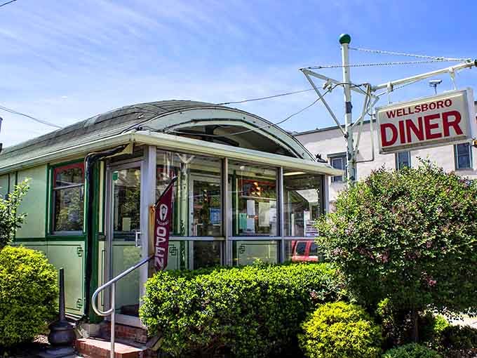 The welcoming entrance with its "OPEN" sign beckons hungry travelers and loyal locals alike through those doors.