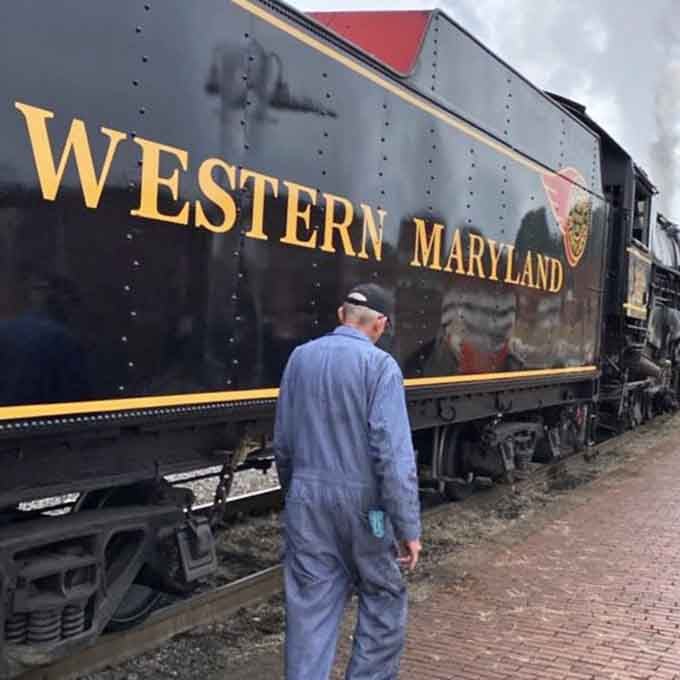 Crew members inspect the Western Maryland tender, keeping these vintage beauties running with skill and dedication.