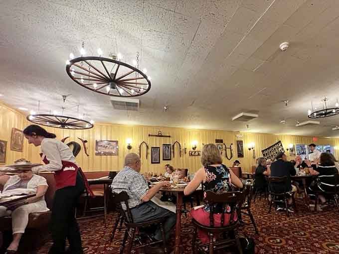 Diners sharing platters family-style, proving that the best meals still happen when we pass food around together.