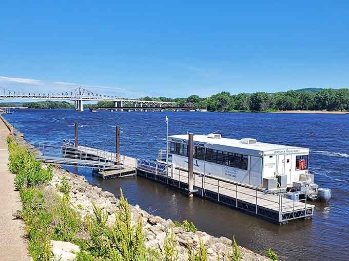 Tour boats dock along the levee where the mighty Mississippi still moves commerce and tourists with equal efficiency and timeless grace.