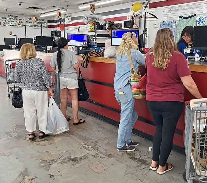 The checkout line where dreams become reality and your cart's contents officially become your treasured possessions.