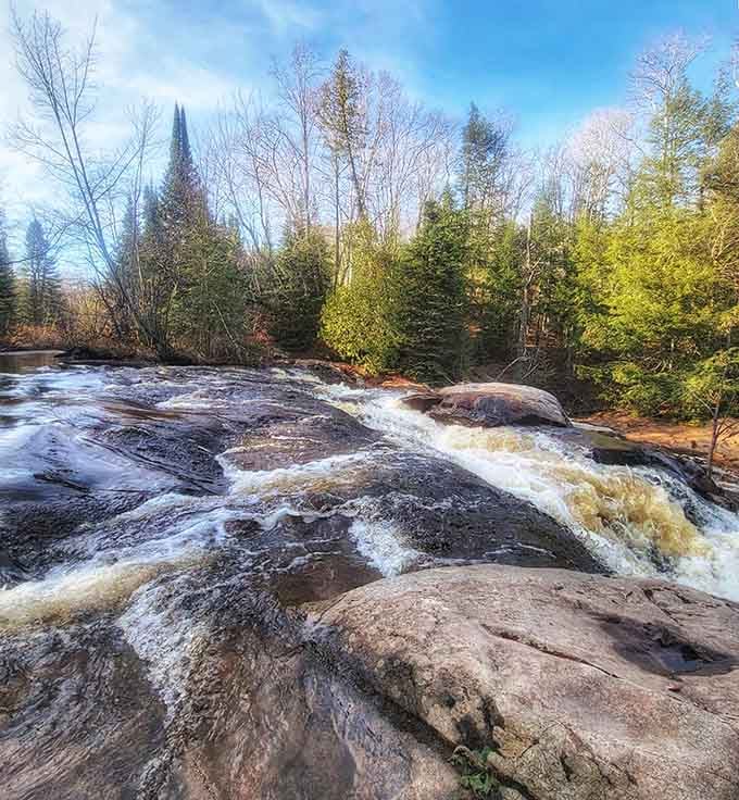 Golden light filters through the trees, turning an ordinary waterfall visit into something almost magical.