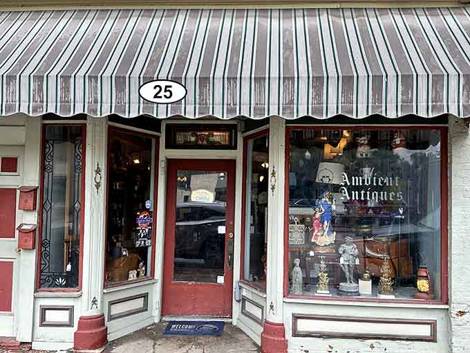 Ambient Antiques' striped awning and classic storefront make window shopping feel like a legitimate recreational activity worth pursuing.