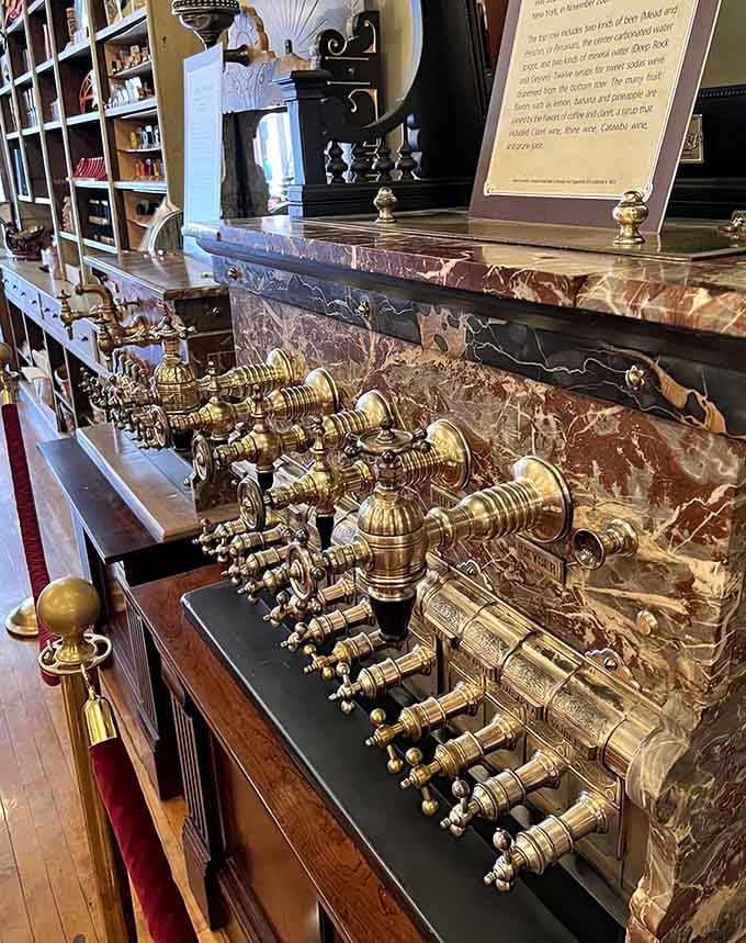 Those brass fountain taps against red marble look like they could dispense either soda or liquid gold, honestly.