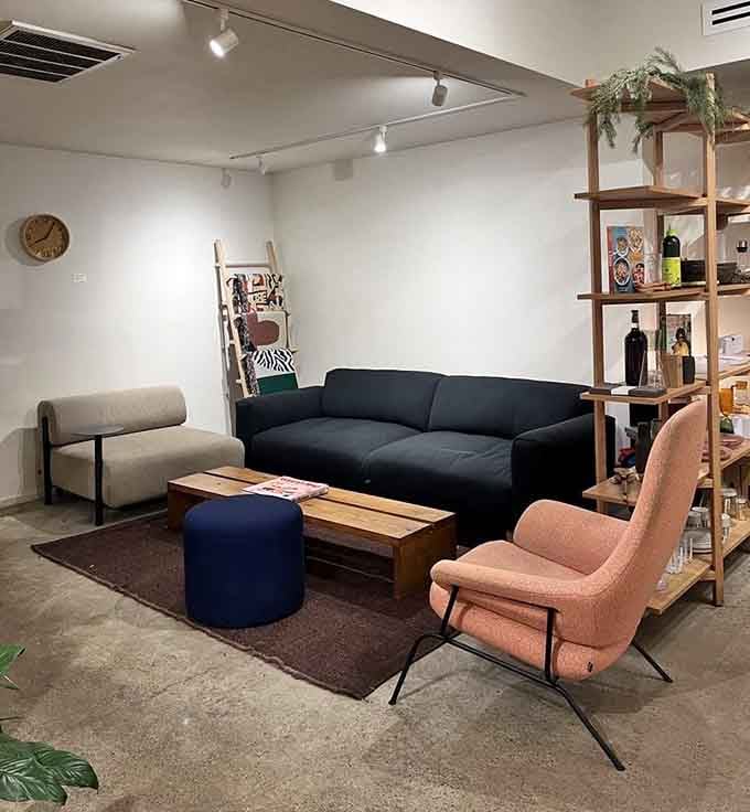 Mid-century modern seating in jewel tones invites you to sink in and stay, turning a quick coffee stop into an afternoon affair.