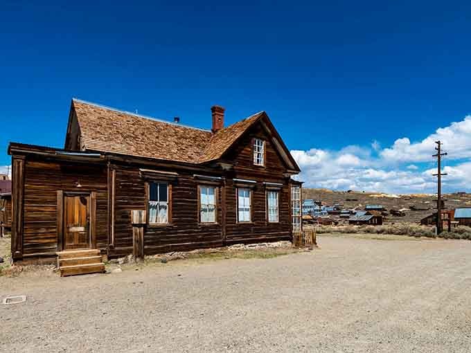 Weathered wood and dusty streets create an authentic ghost town scene where time literally stopped and history stands perfectly still.