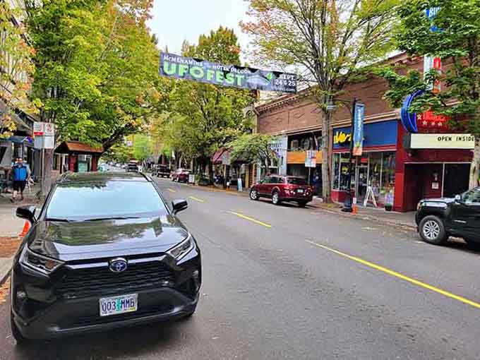 Tree-lined boulevards create natural tunnels of shade perfect for leisurely strolls with coffee in hand, smiling.