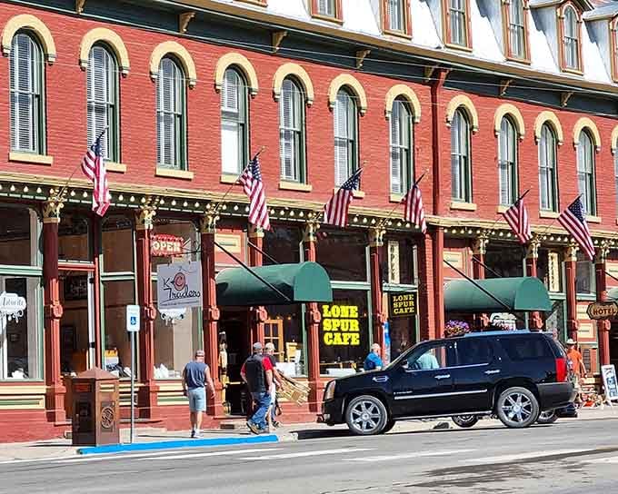 American flags flutter above storefronts where the Lone Star Cafe promises hearty meals and friendly service.