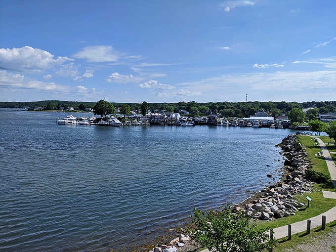 Blue water stretches toward tree-lined shores where summer days unfold at a perfectly relaxed pace.
