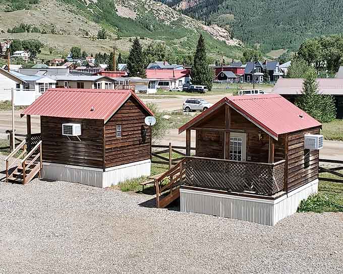 Rustic cabins with red roofs offer simple mountain living where modern conveniences take a welcome backseat.