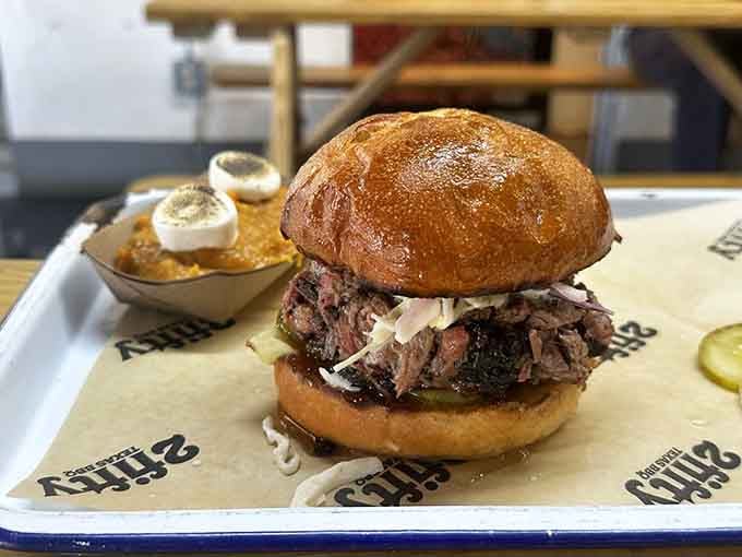 A brisket sandwich this loaded requires both hands, several napkins, and absolutely zero regrets about your life choices.