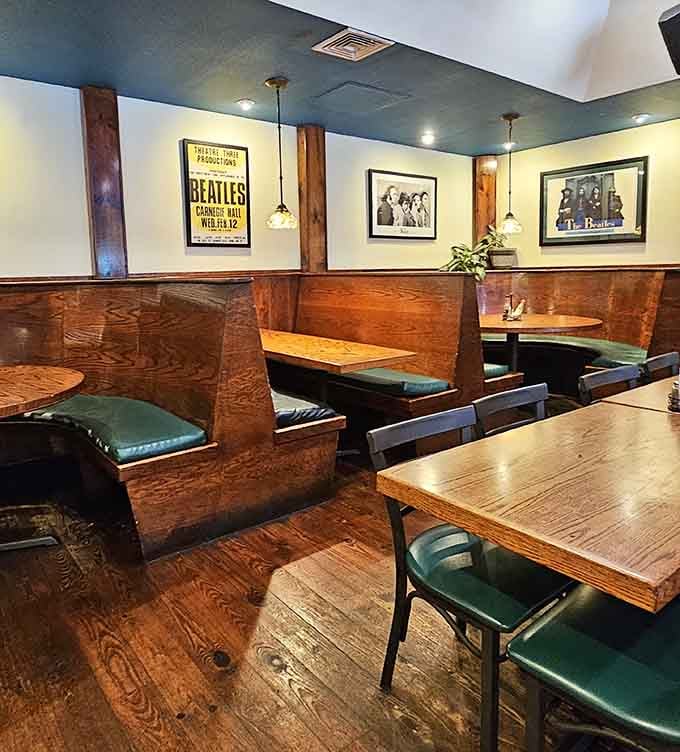 Booth seating with Beatles concert posters overhead offers intimate spaces for conversations and contemplation over good food.