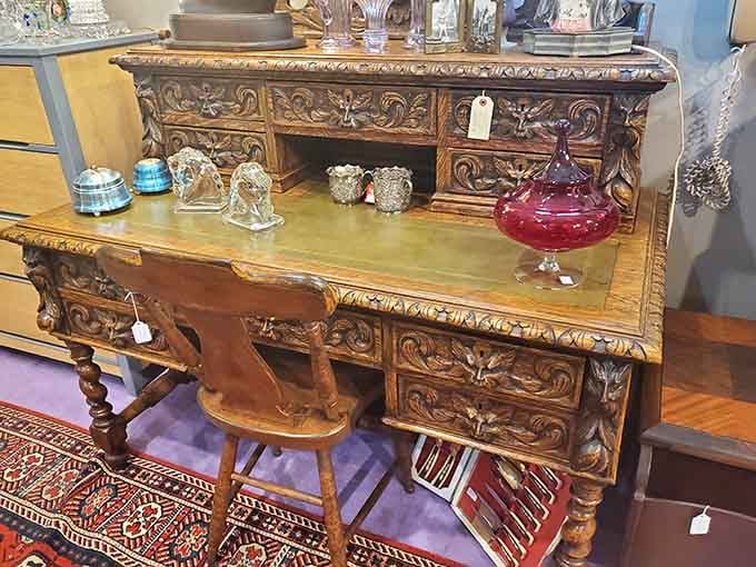 An ornately carved writing desk that makes you want to pen handwritten letters like a proper Victorian gentleman.