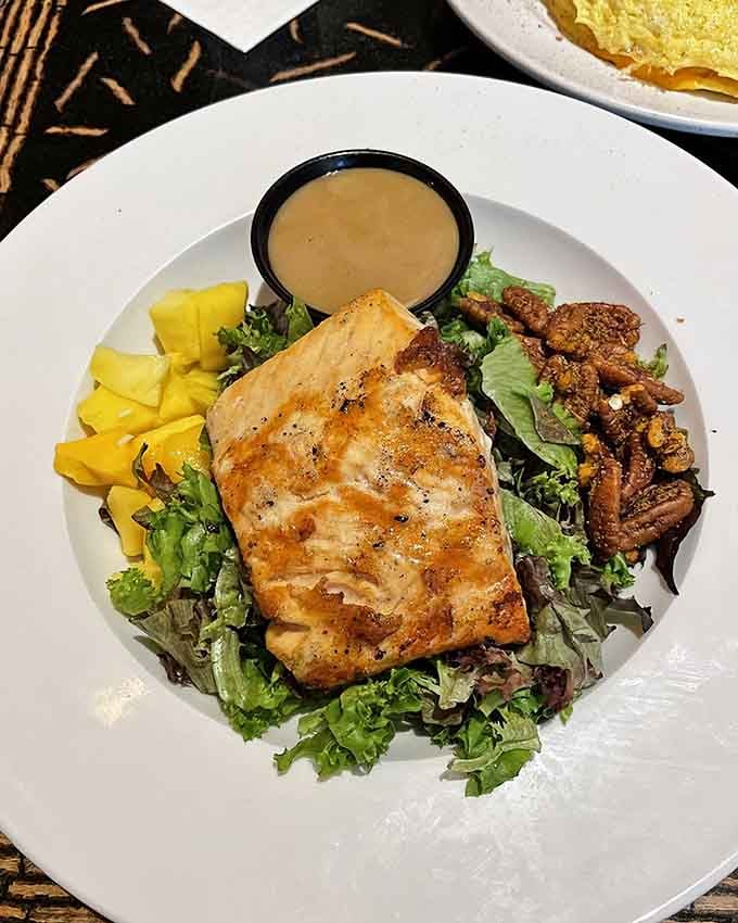 Fresh salmon crowns a bed of greens, proving healthy eating doesn't have to mean sacrificing flavor or satisfaction.