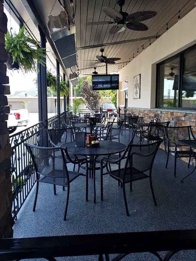 Covered outdoor patio with fans overhead, perfect for enjoying those enormous meals while pretending the fresh air cancels calories.