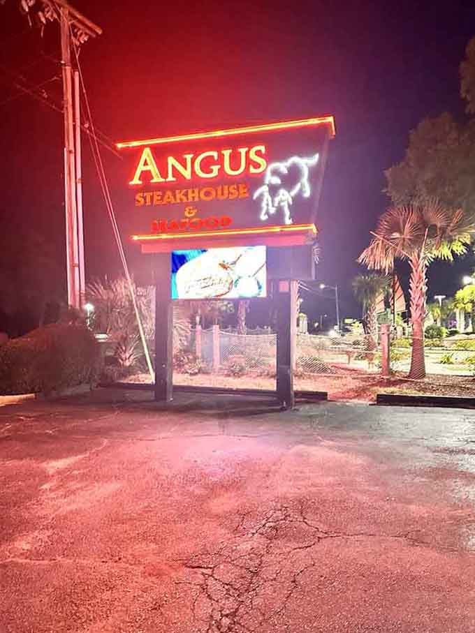 The glowing sign beckons hungry travelers, visible from the road like a carnivore's lighthouse beacon.