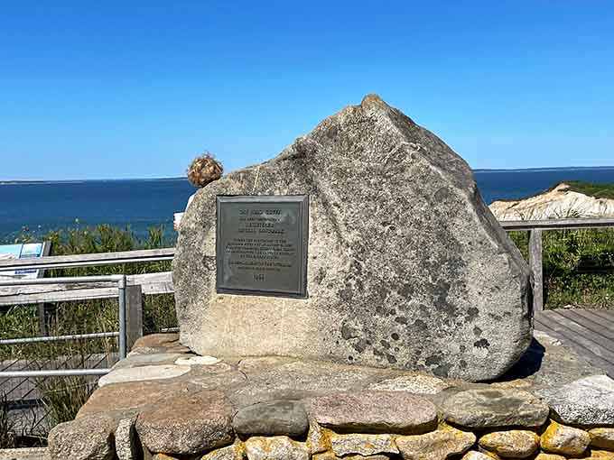 A weathered memorial stone marks sacred ground, reminding visitors this beauty carries deep cultural significance.
