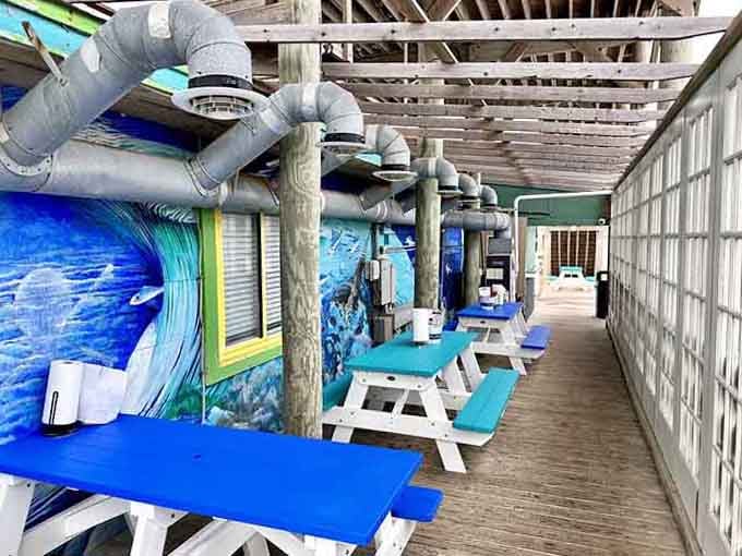 Ocean-blue murals transform the outdoor patio into a breezy dining space where flip-flops are practically formal wear.
