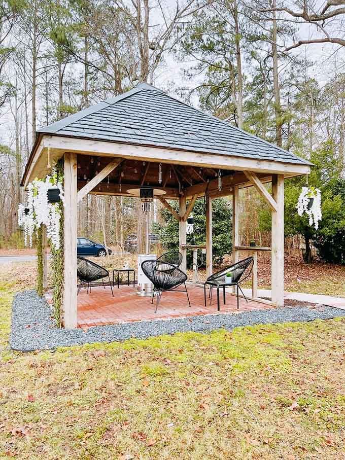 A wooden gazebo surrounded by nature offers the perfect escape for sipping coffee and avoiding adult responsibilities.