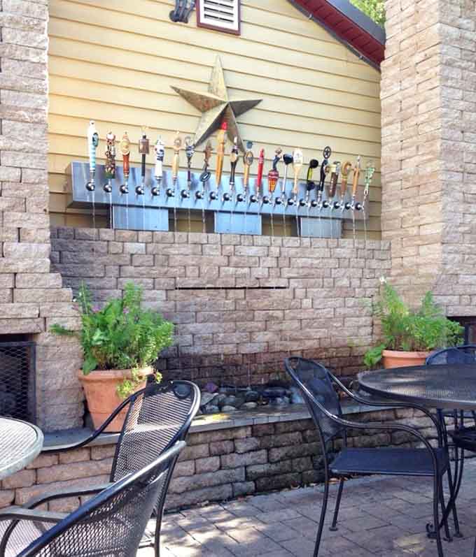 An outdoor patio with tap handles on display means serious beverage options await your pizza pairing.