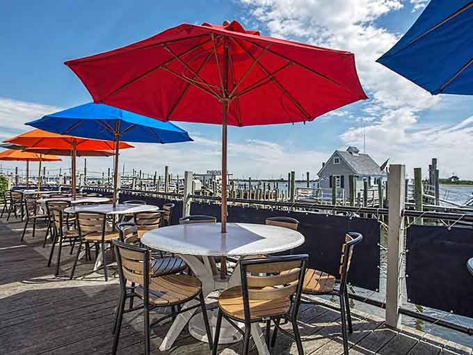Outdoor seating with colorful umbrellas and marina views turns a simple meal into a waterfront experience worth savoring slowly and gratefully.