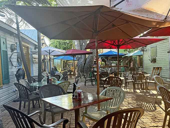 Outdoor seating under umbrellas where roosters patrol and time slows down to a proper island crawl, finally.