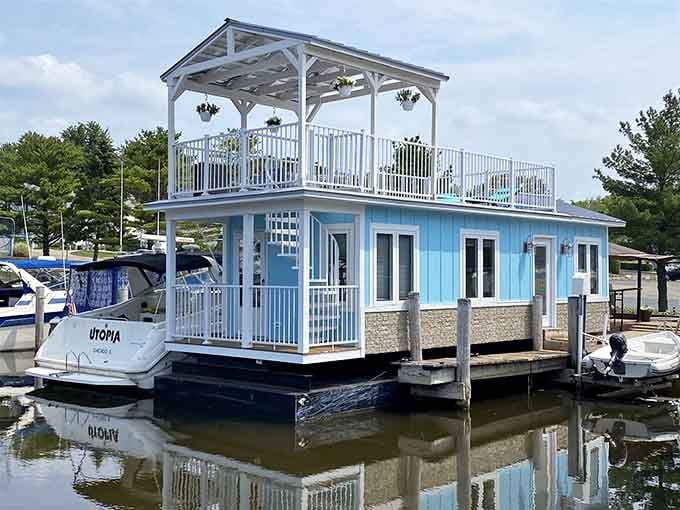 The cheerful blue exterior and white pergola top make this floating cottage look like it sailed straight from paradise.