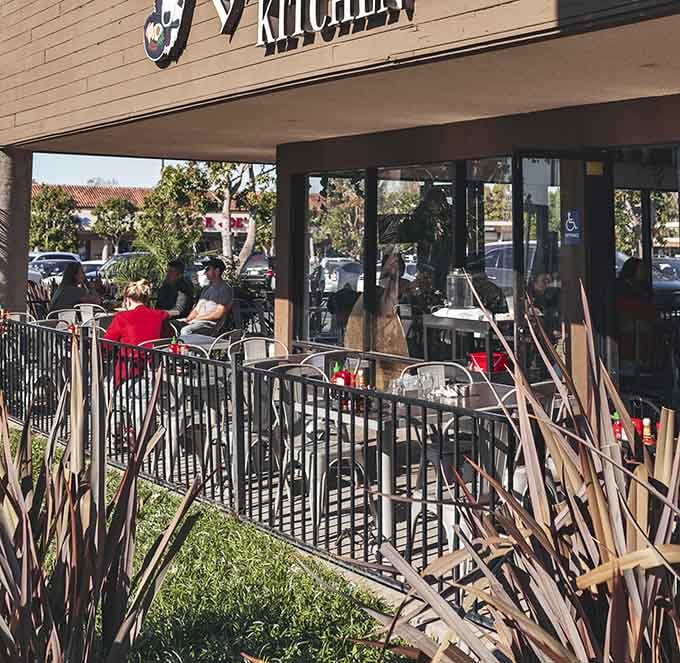The outdoor patio beckons with metal chairs and California sunshine for perfect al fresco dining.