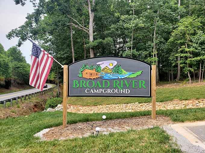 The welcoming sign promises riverside adventures without the usual camping misery you've learned to expect and dread.