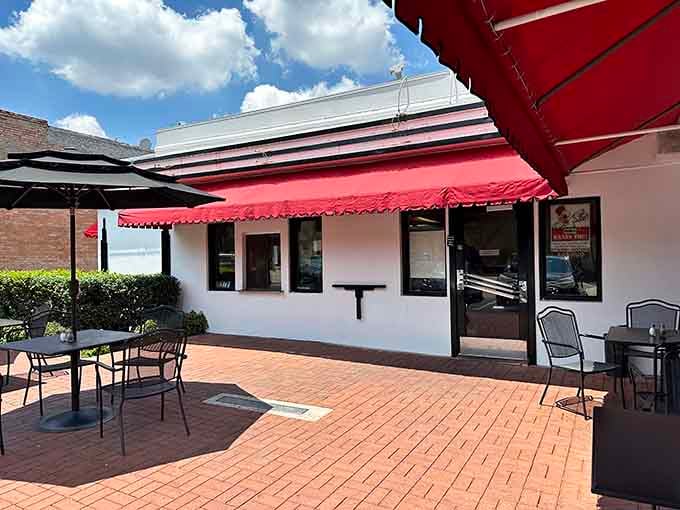 The outdoor patio offers fresh air dining under those signature red awnings on beautiful Dallas days.