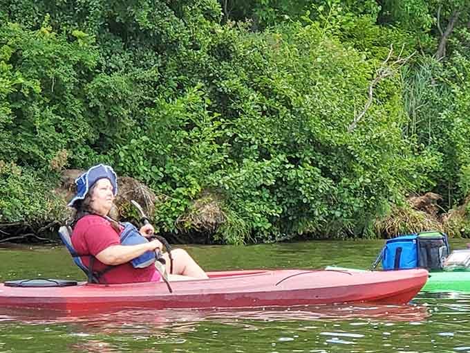 Kayaker floating peacefully along the Illinois River, living proof that adventure doesn't require airplane tickets.