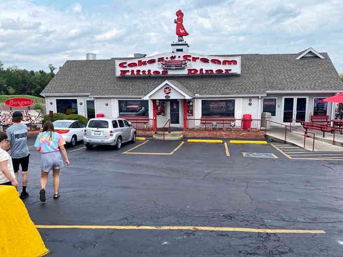 By day, the red exterior charms passersby; by night, that rooftop sign becomes a beacon for the hungry.