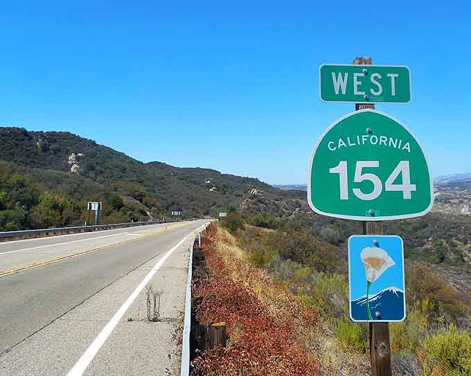 That green Route 154 sign marks the gateway to scenery that makes forgetting the freeway ridiculously easy.