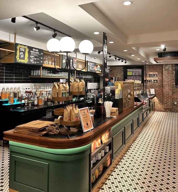 The counter area gleams with that classic green trim, where your coffee dreams become caffeinated reality every single day.