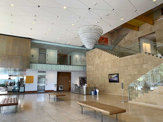 The entrance lobby welcomes visitors with soaring ceilings and that distinctive chandelier, setting expectations sky-high immediately.