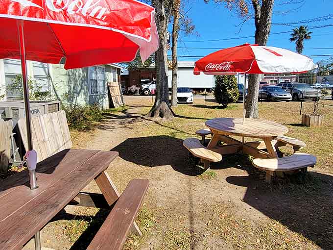 Picnic tables under Coca-Cola umbrellas where calories don't count and every meal feels like a summer celebration.