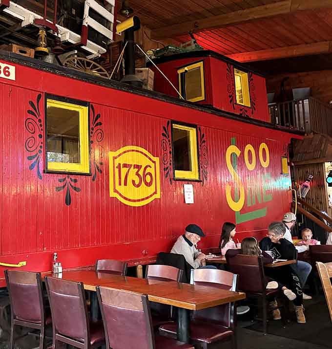 Diners enjoy their meals beside the iconic caboose, living out childhood dreams one delicious bite at a time.