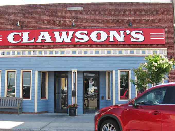 That blue exterior with white trim and potted plants says "come on in" louder than any neon sign ever could.