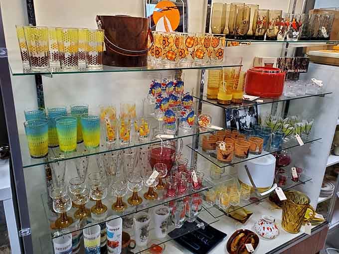 Colored glassware catches light like liquid sunshine, from amber to turquoise, proving drinking vessels were once genuinely exciting purchases.