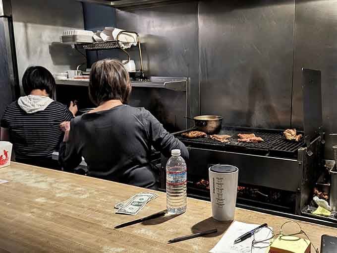 The hands behind the grill working their daily magic, turning simple ingredients into neighborhood legends one plate at a time.