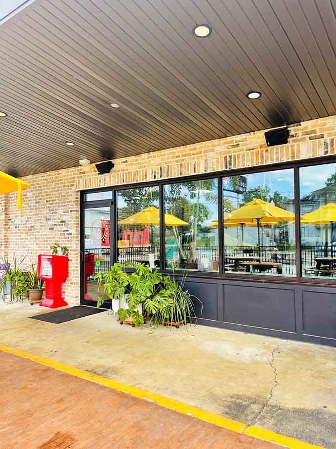 The entrance welcomes you with brick, plants, and the promise that something extraordinary awaits just beyond those doors.