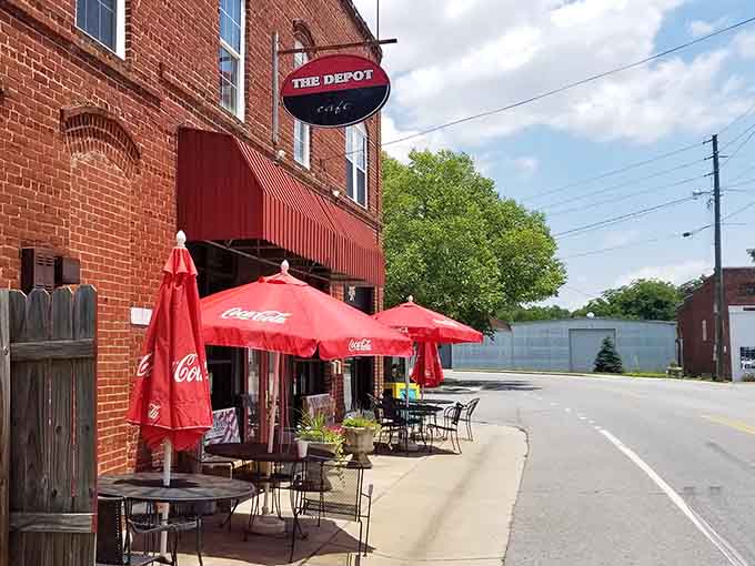 Outdoor seating under red umbrellas lets you enjoy your meal while watching small-town life unfold around you.