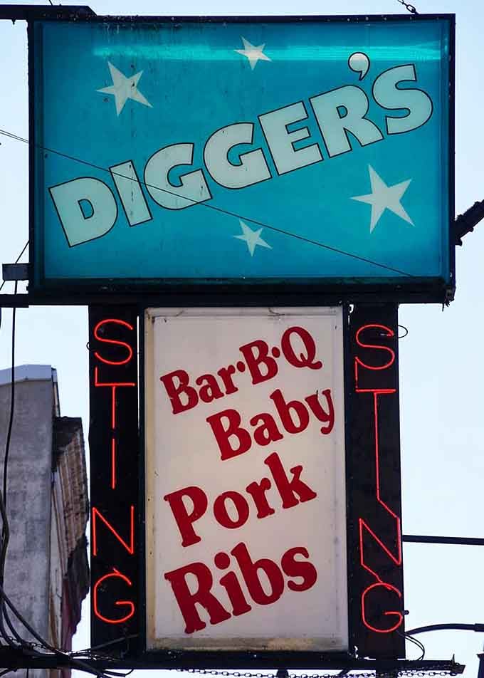 That vintage sign beckons hungry travelers with promises of BBQ baby back ribs that deliver on every word.
