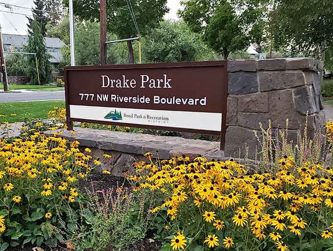 The welcoming sign at Drake Park promises simple pleasures: grass, trees, water, and the good sense to enjoy them.