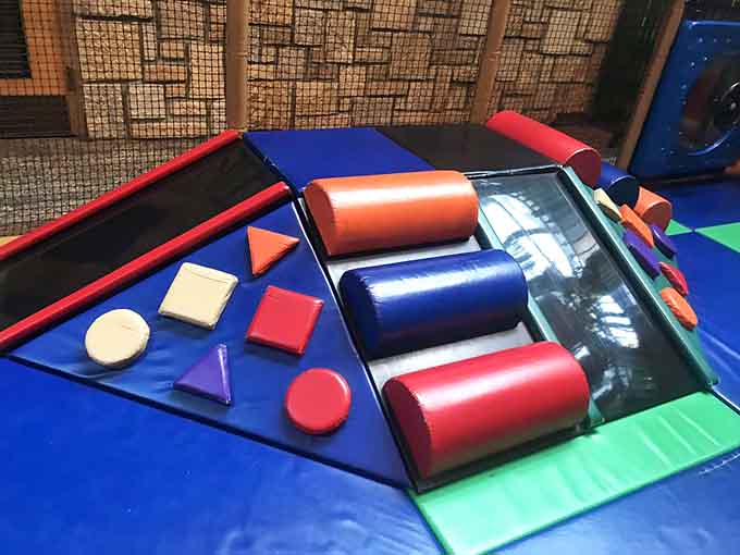 Soft geometric shapes create obstacle courses that challenge young bodies without terrifying their watchful, slightly anxious parents nearby.