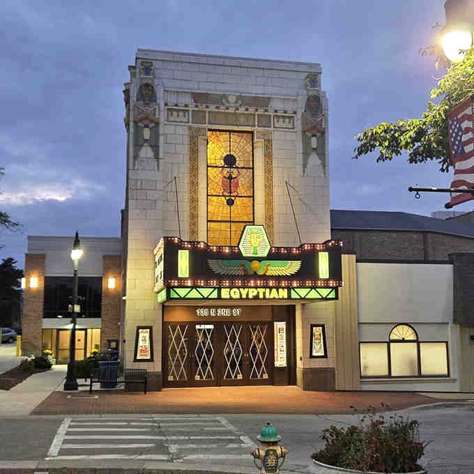 As twilight descends, the illuminated facade glows like a beacon calling you to experience movie magic.